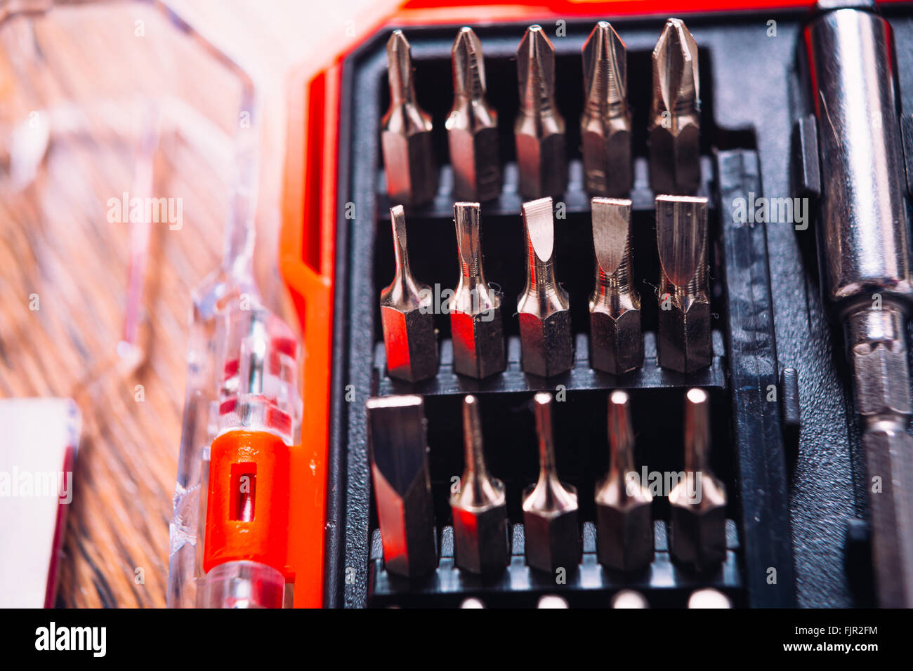 set of nozzles for screwdriver in red box on wooden background Stock ...