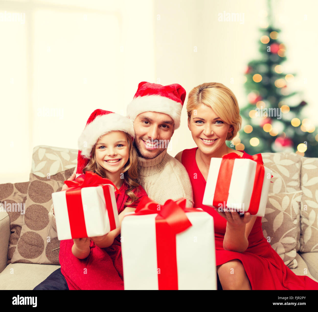 smiling family giving many gift boxes Stock Photo - Alamy