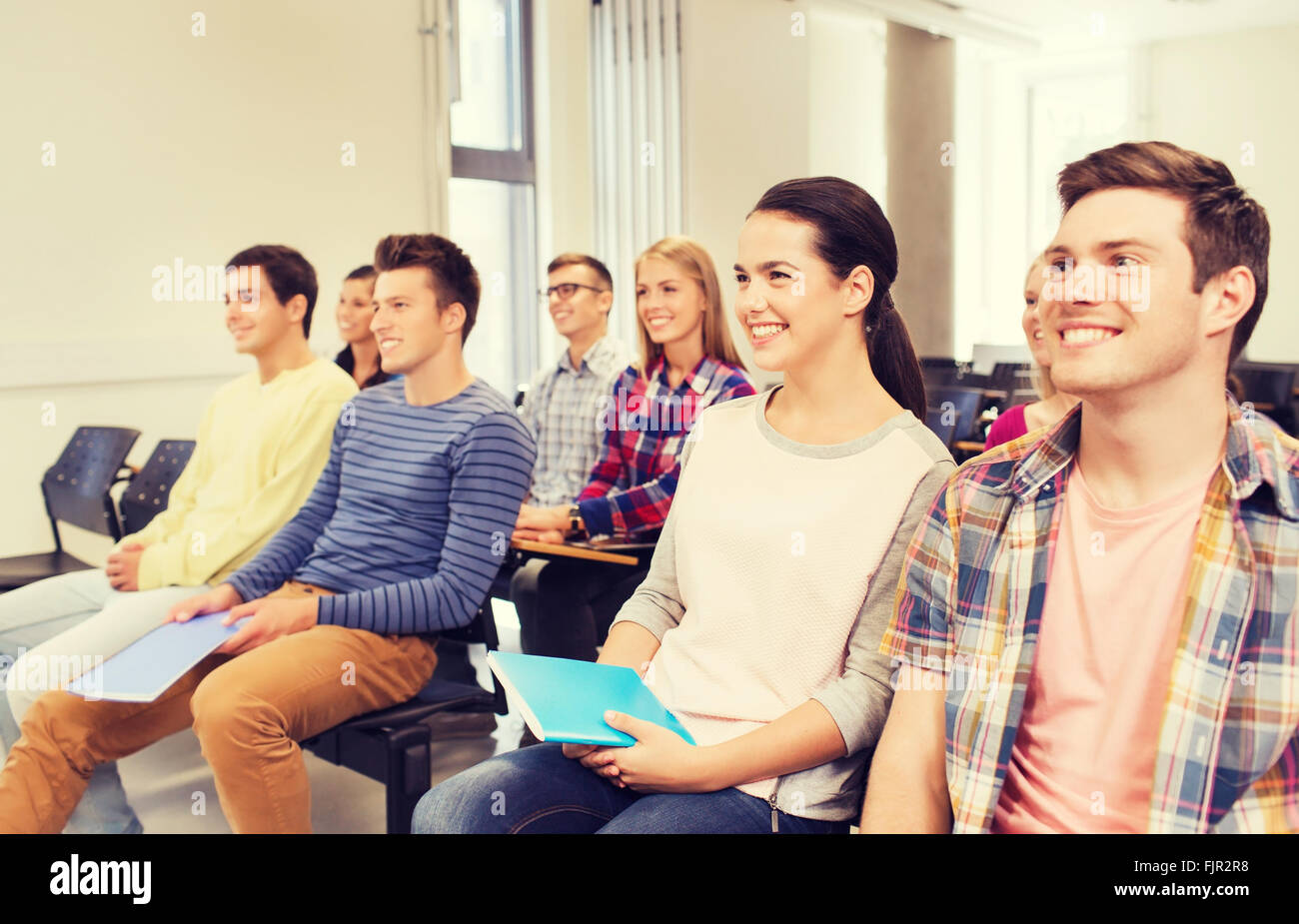 group of smiling students in lecture hall Stock Photo - Alamy
