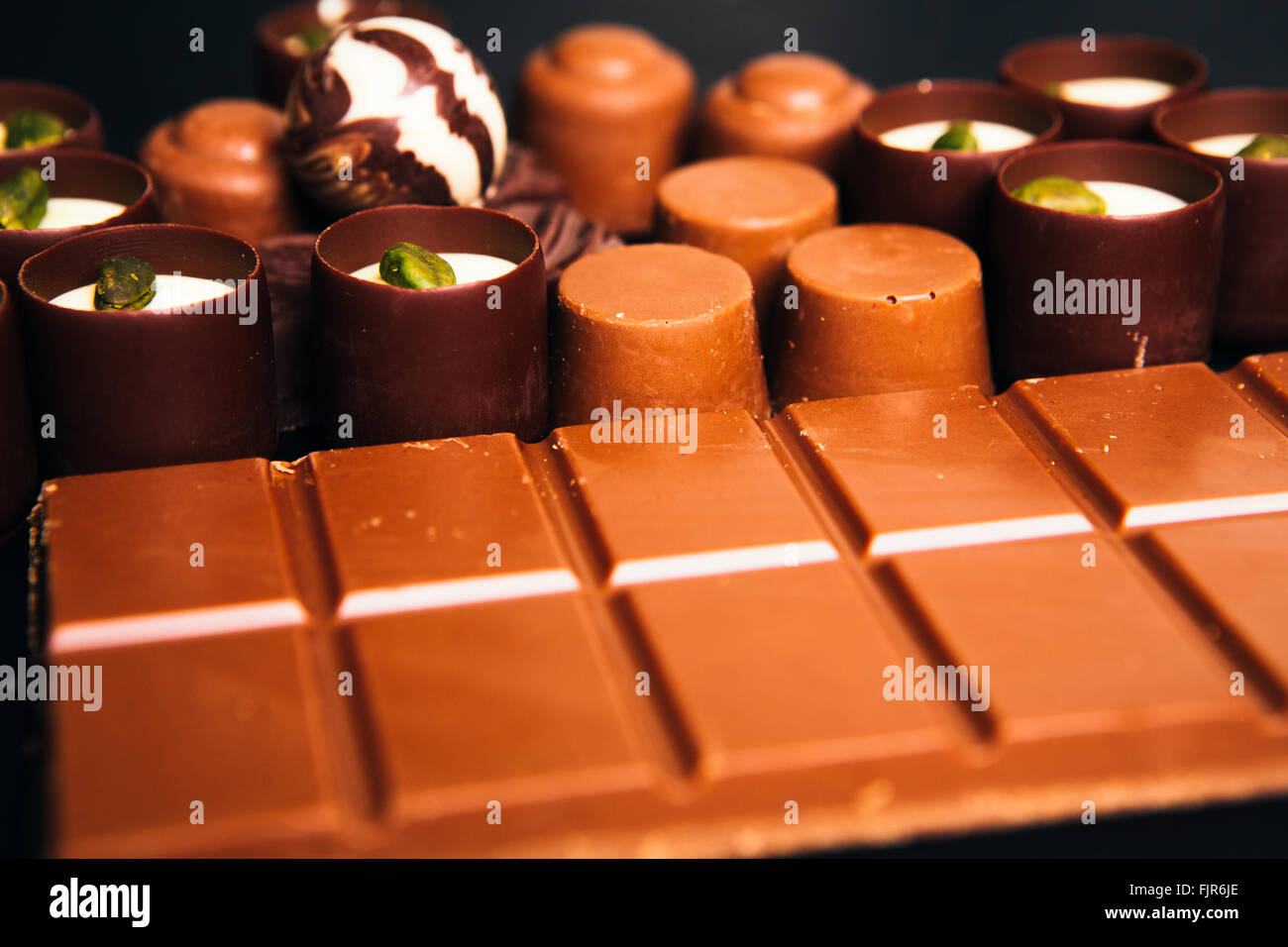 Many chocolate sweets with Pistachio on black background Stock Photo ...