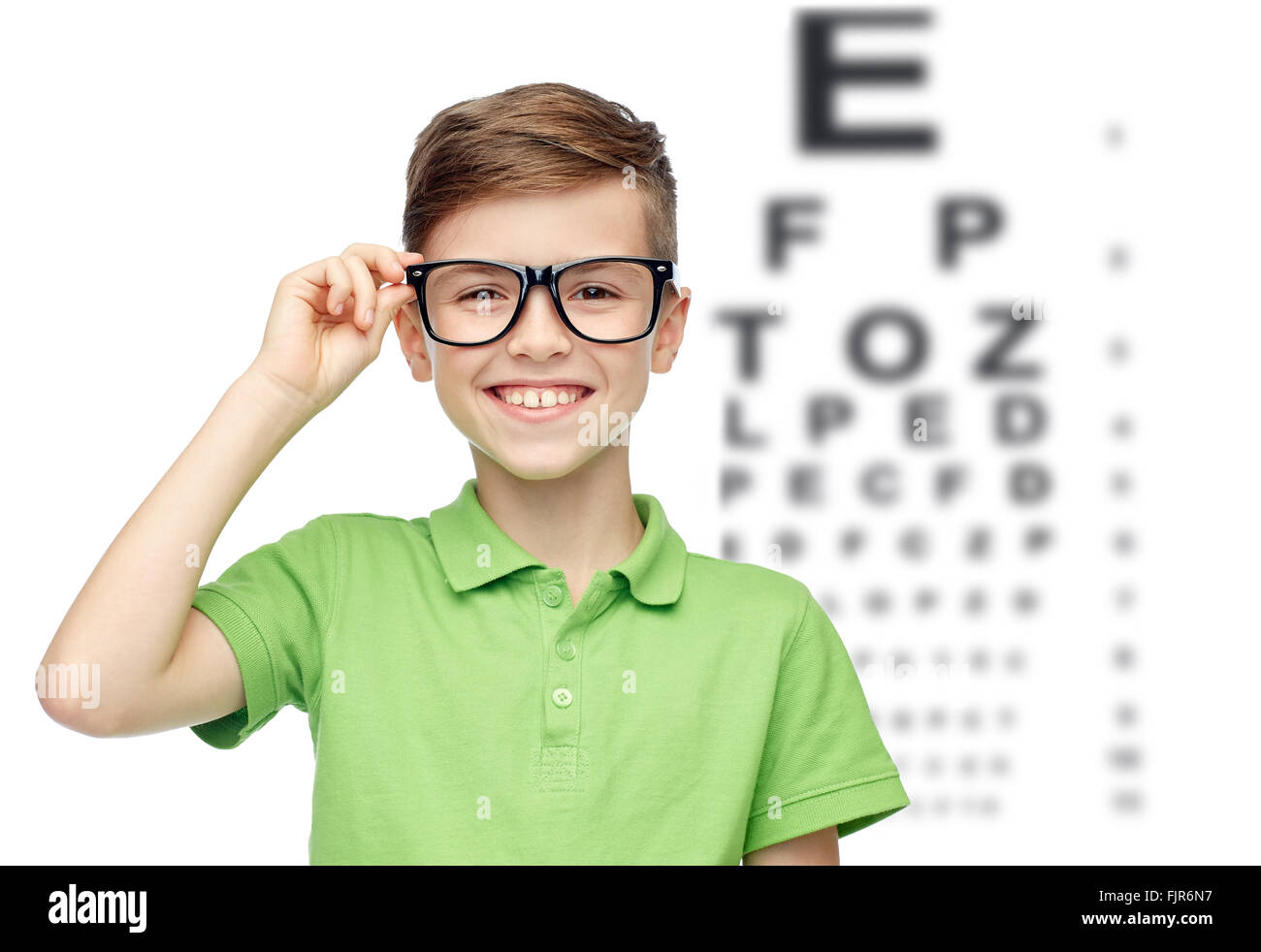 happy boy in eyeglasses over eye chart Stock Photo - Alamy