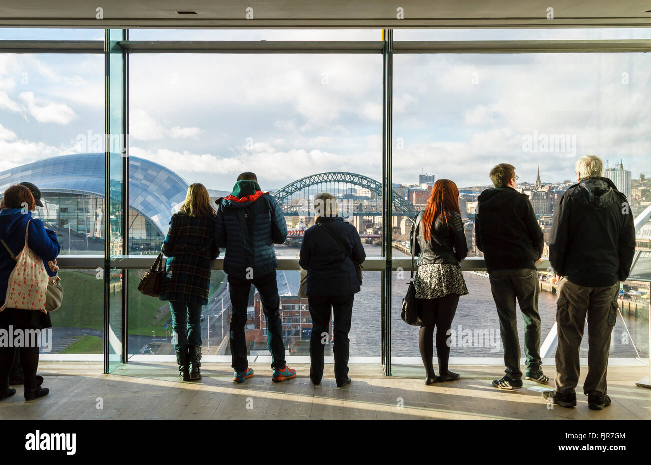 People looking out the window of the Baltic at the city view of ...