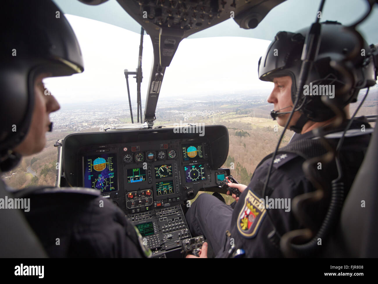 Police helicopter pilots Christian Lange (R) and Thomas Meyer steer a ...