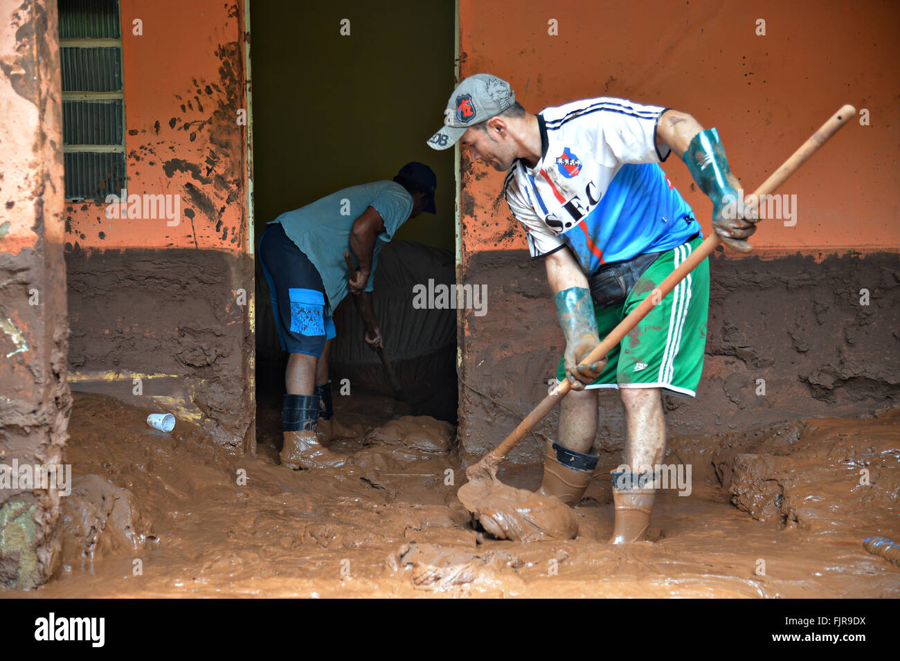Men clean up toxic mud covering the city of Mariana in the Brazilian ...