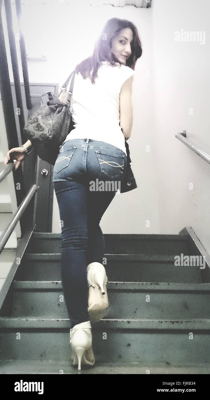 Portrait Of Young Woman Moving Up On Steps Stock Photo - Alamy