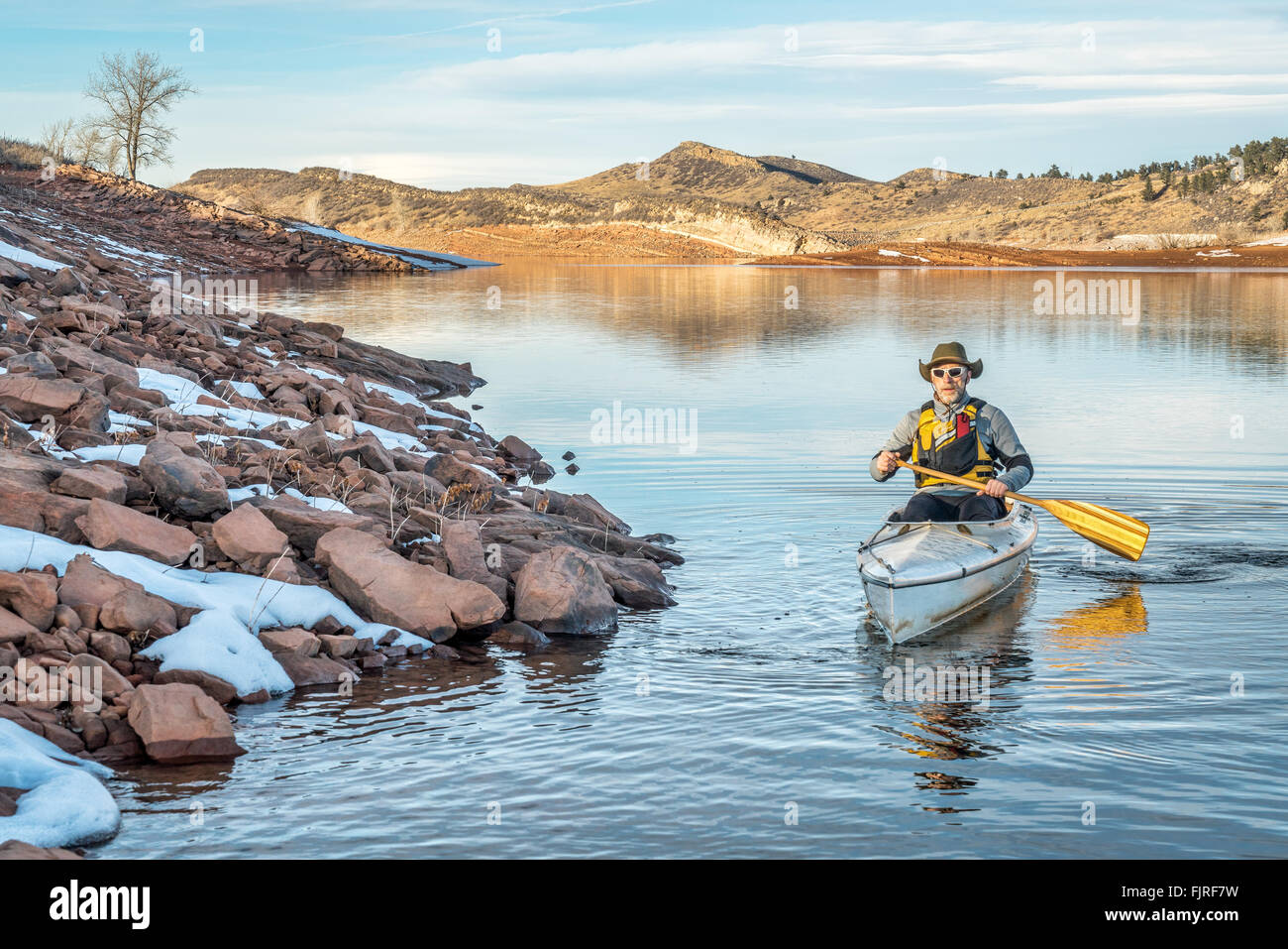 senior male paddling a decked expedition canoe on Horsetooth Reservoir ...
