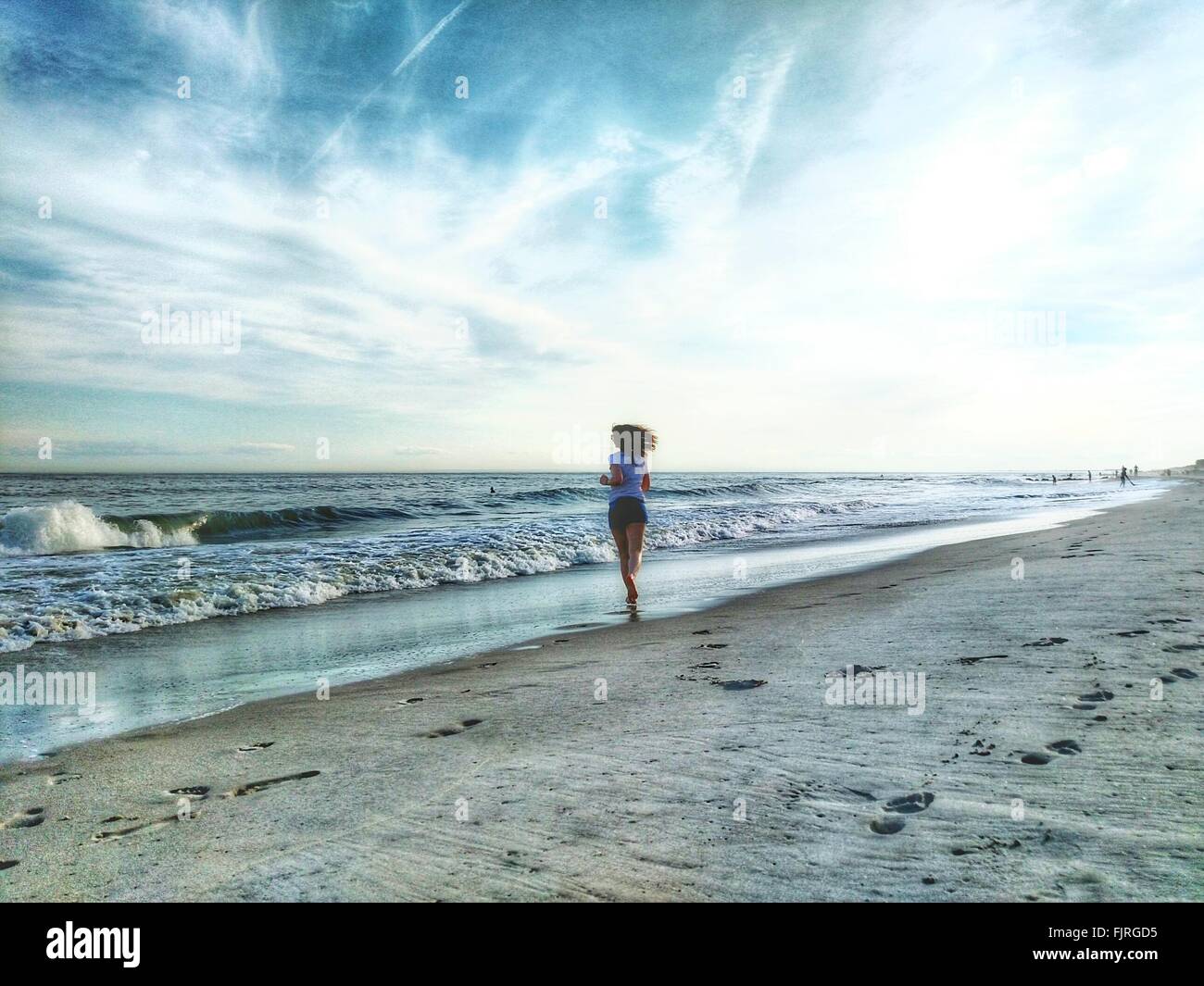 Woman running beach beach hi-res stock photography and images - Alamy