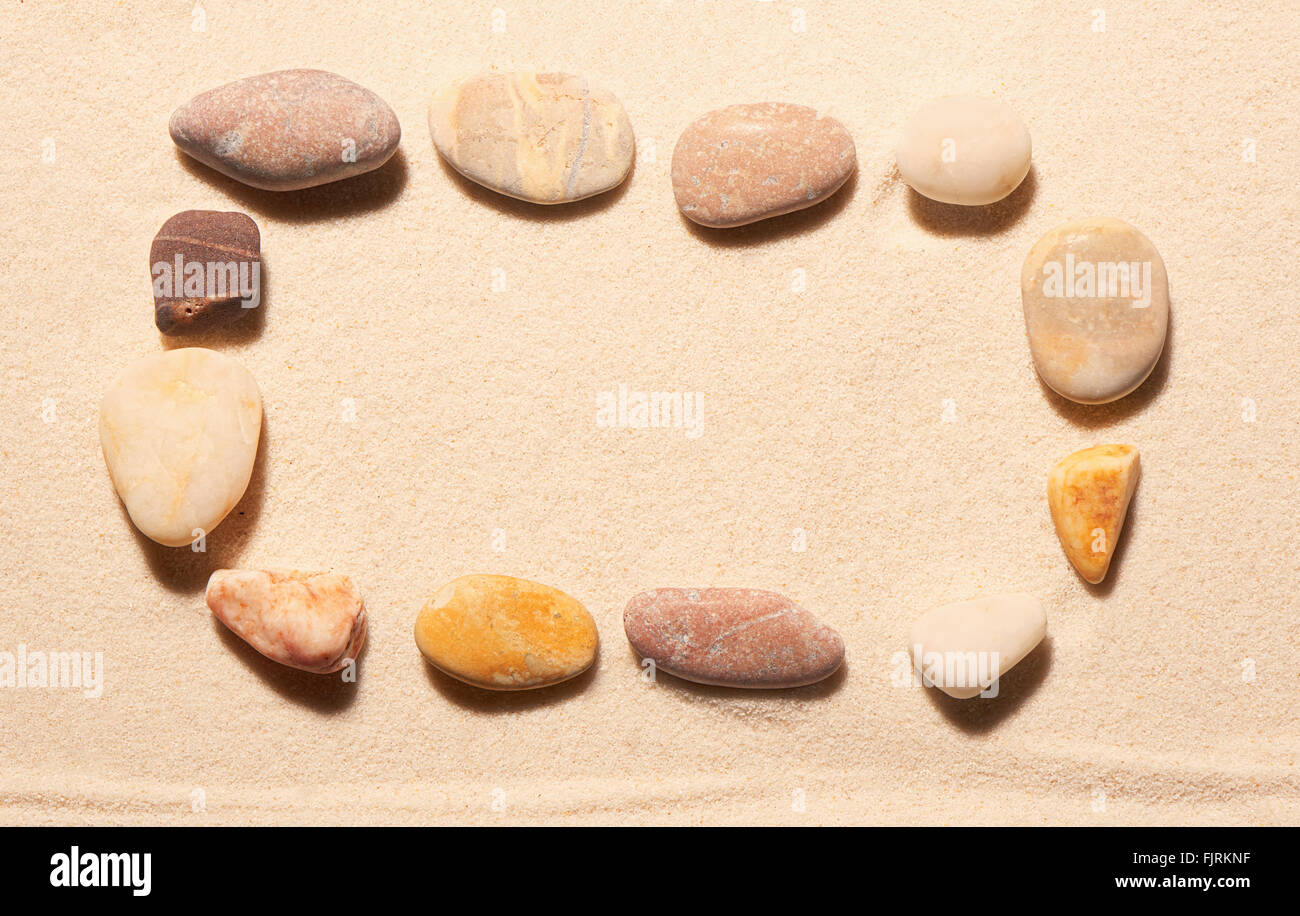 Rectangular frame of sea stones on sand. Summer beach background. View ...