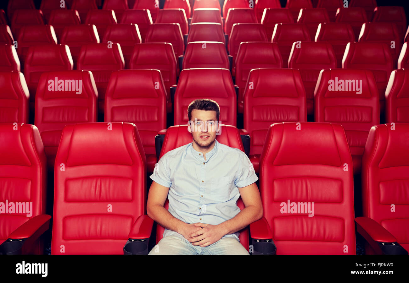 happy young man watching movie in theater Stock Photo - Alamy