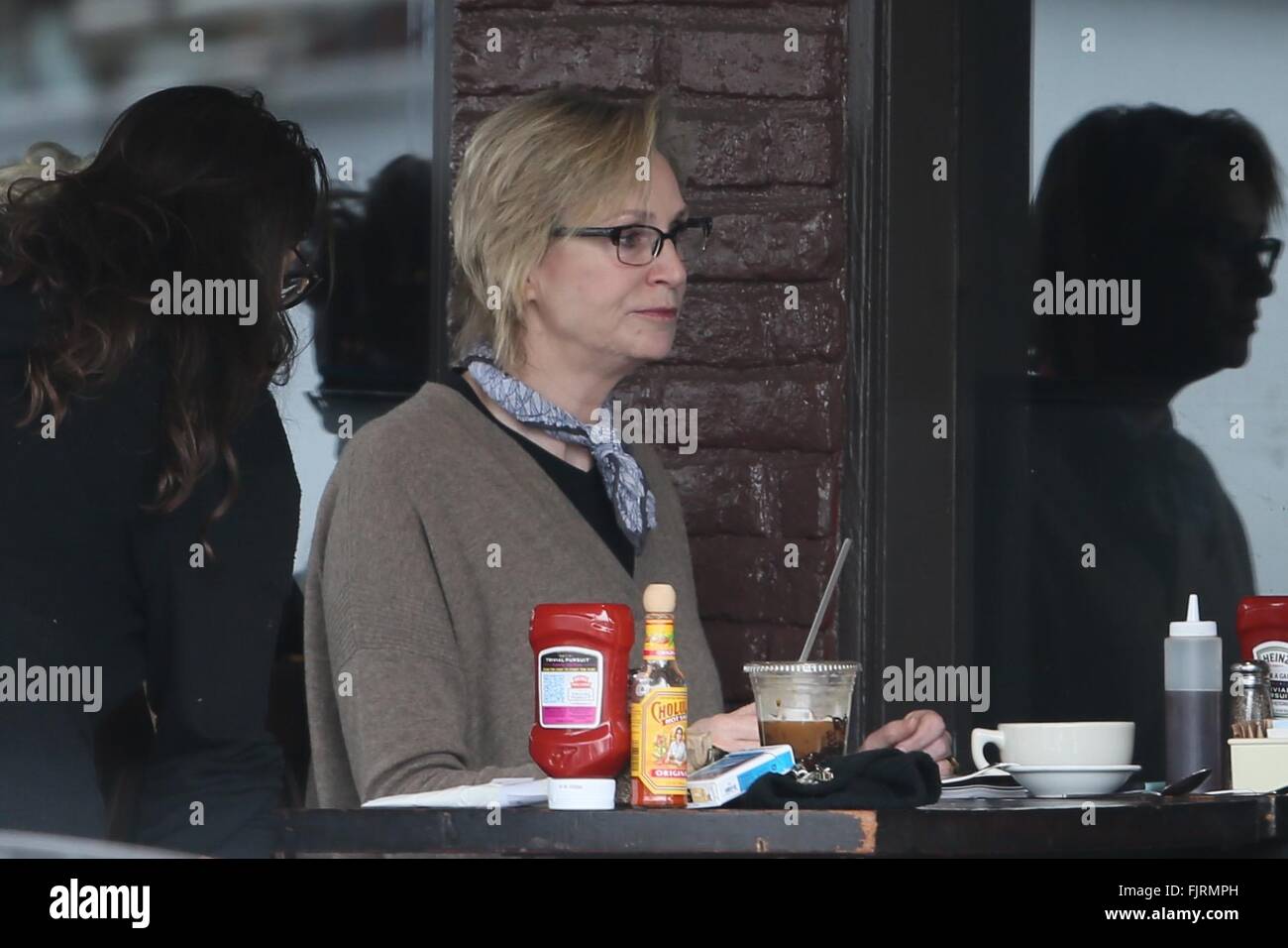 Jane Lynch and friend seen having coffee, Jane gets up to make a phone ...