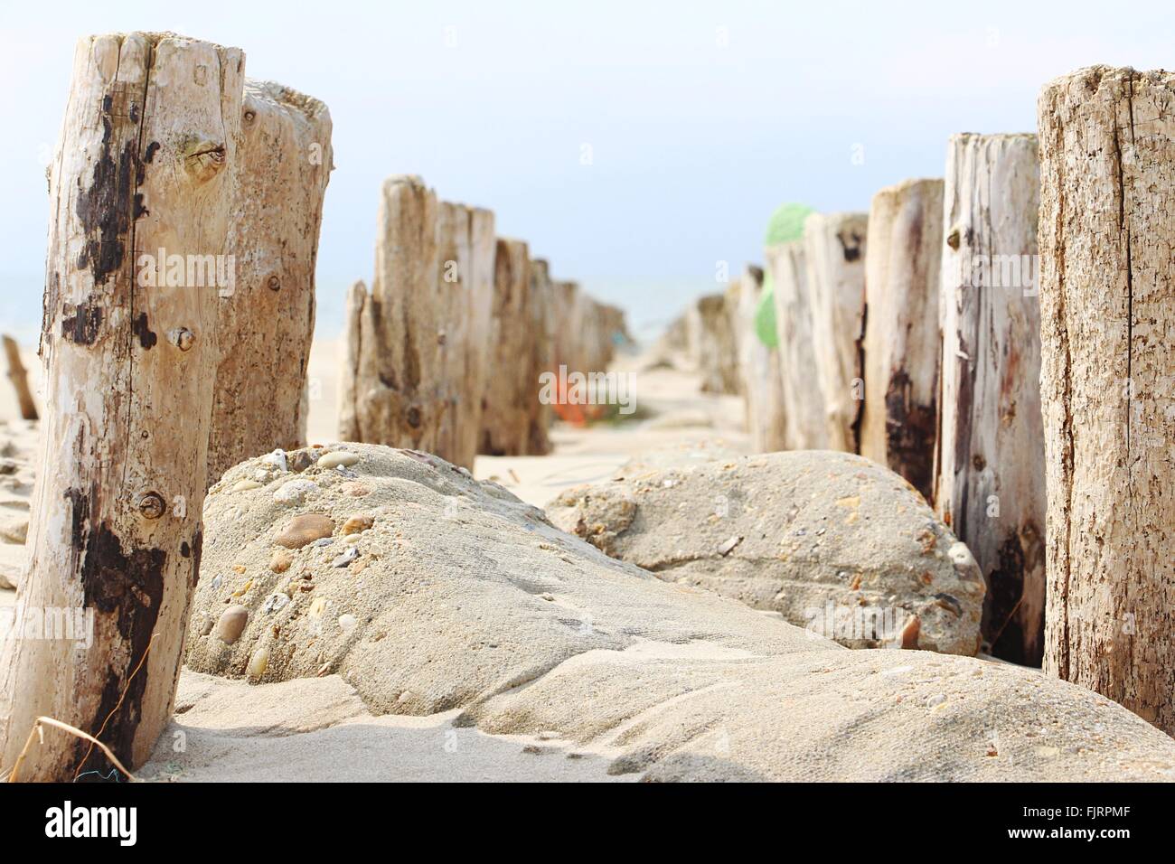 Row wooden post beach rock hi-res stock photography and images - Alamy