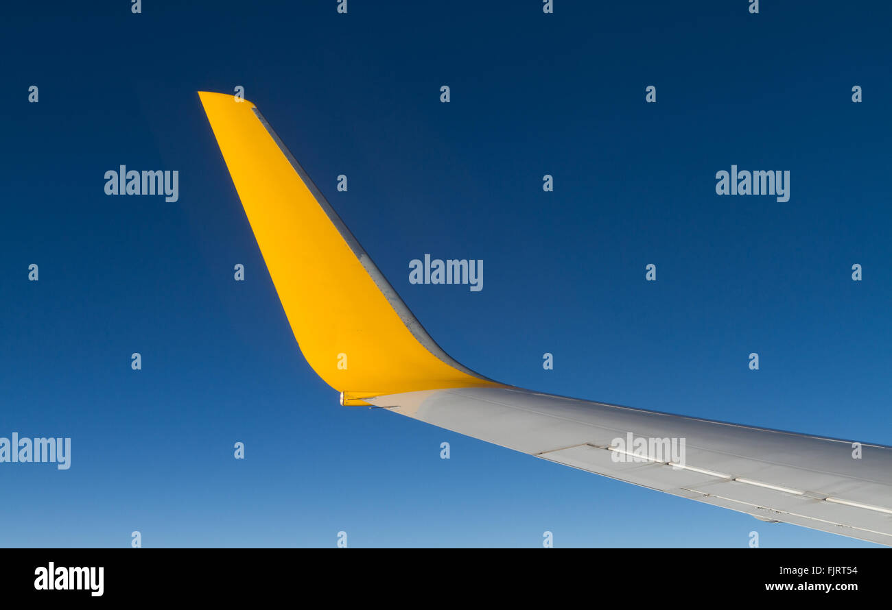 Yellow Airplane Wing and Wingtrip on sky Stock Photo - Alamy