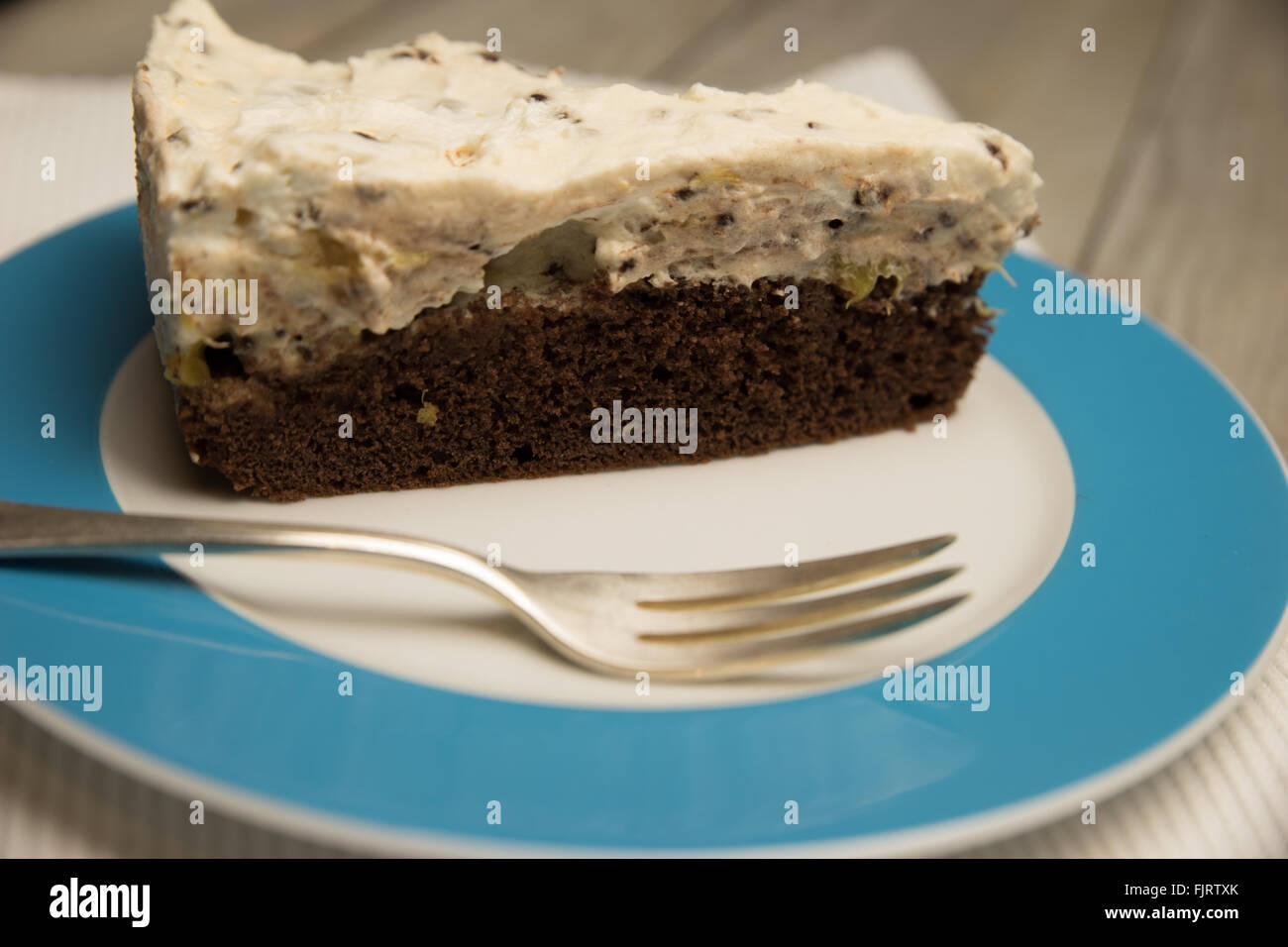 chocolate cream cake on a cyan plate Stock Photo - Alamy