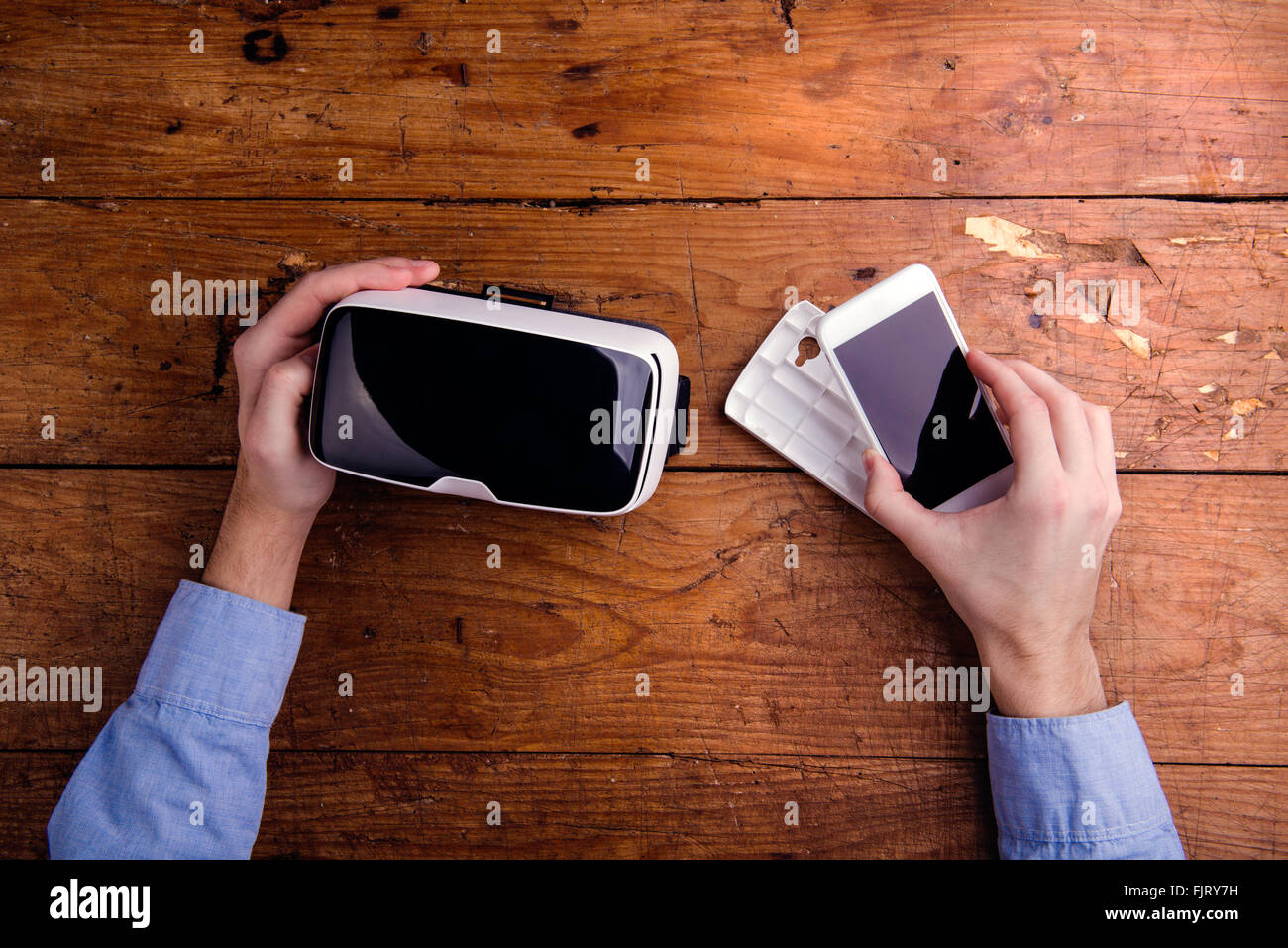 Hands of man holding virtual reality goggles and smartphone Stock Photo ...