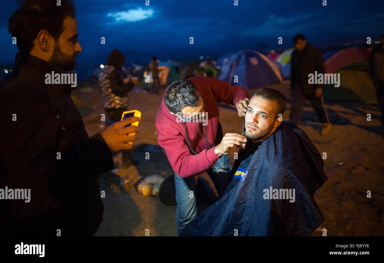 A man shaves the beard of Sayad (R) from Aleppo, Syria, in a refugee ...