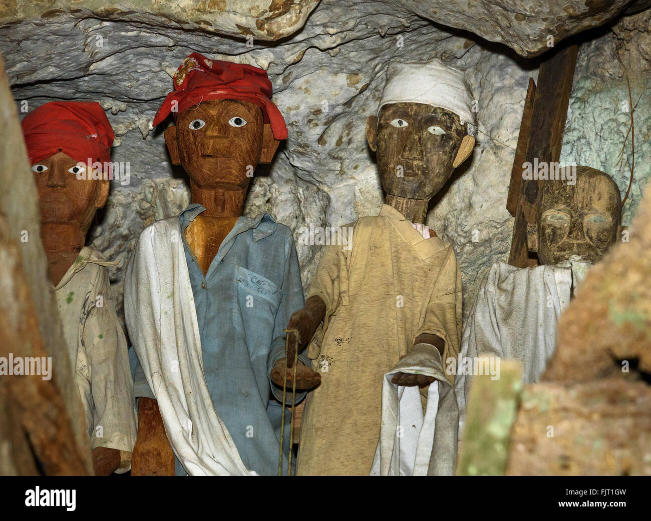 Wooden statues of Tau Tau in Tampang Allo burial cave of the royal ...