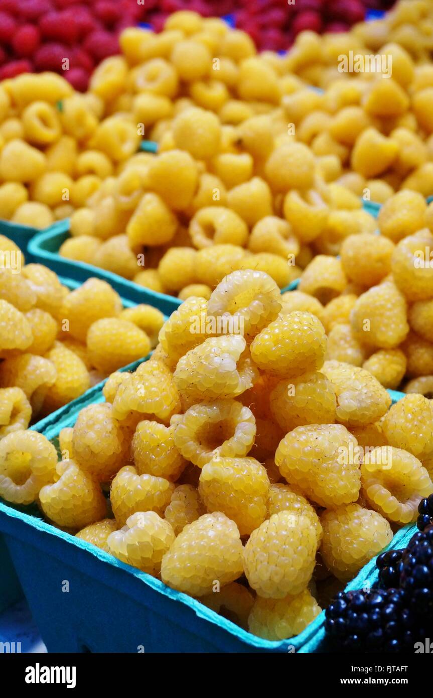 Golden yellow raspberries in containers at the market Stock Photo - Alamy