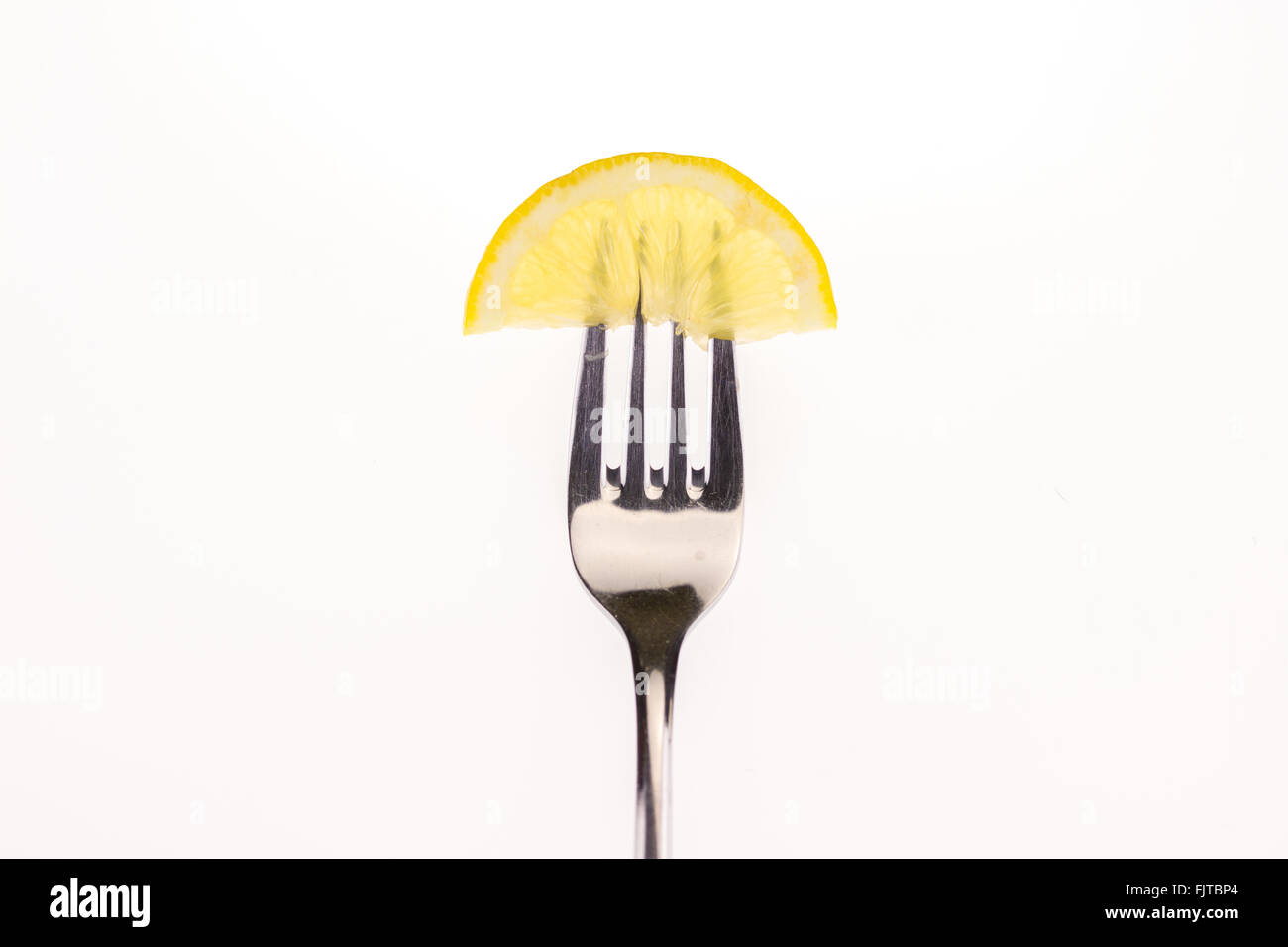 Lemon on fork hi-res stock photography and images - Alamy