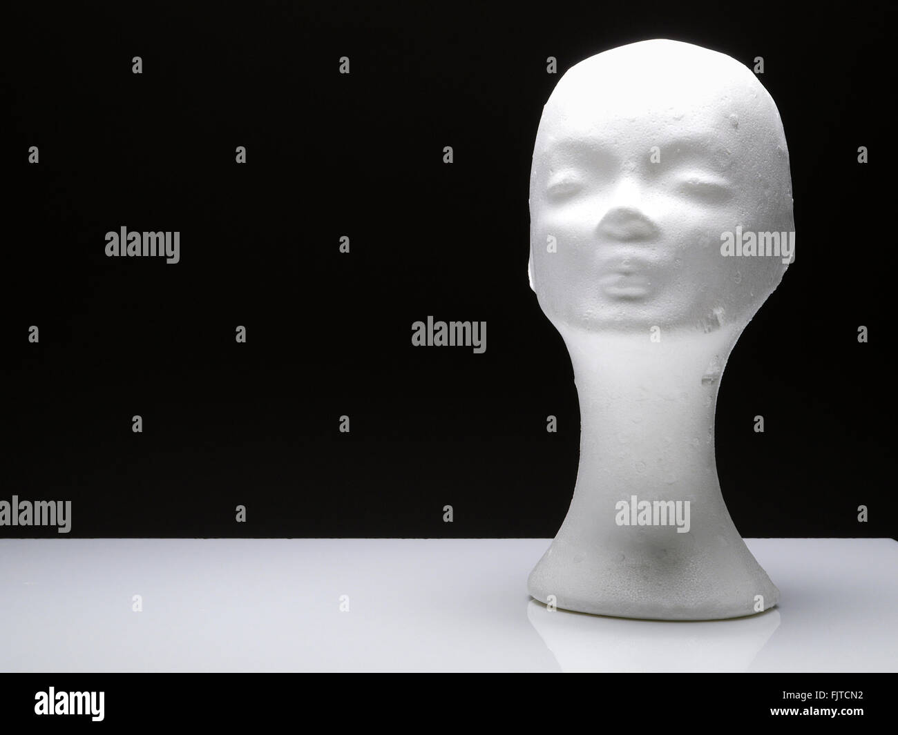 White dummy female head on black background Stock Photo - Alamy