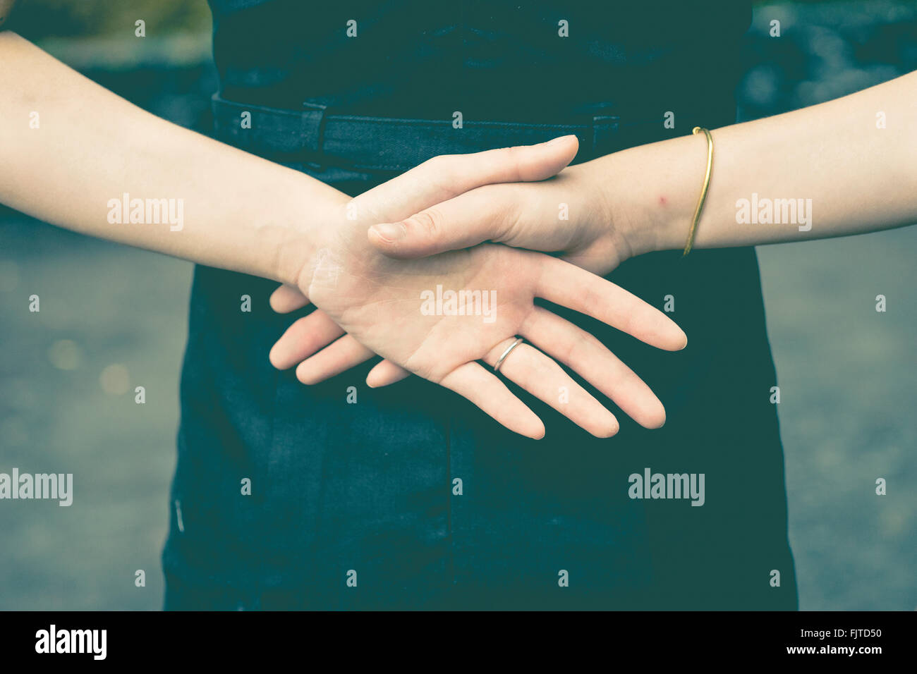 Woman standing with hands behind her back hi-res stock photography and ...