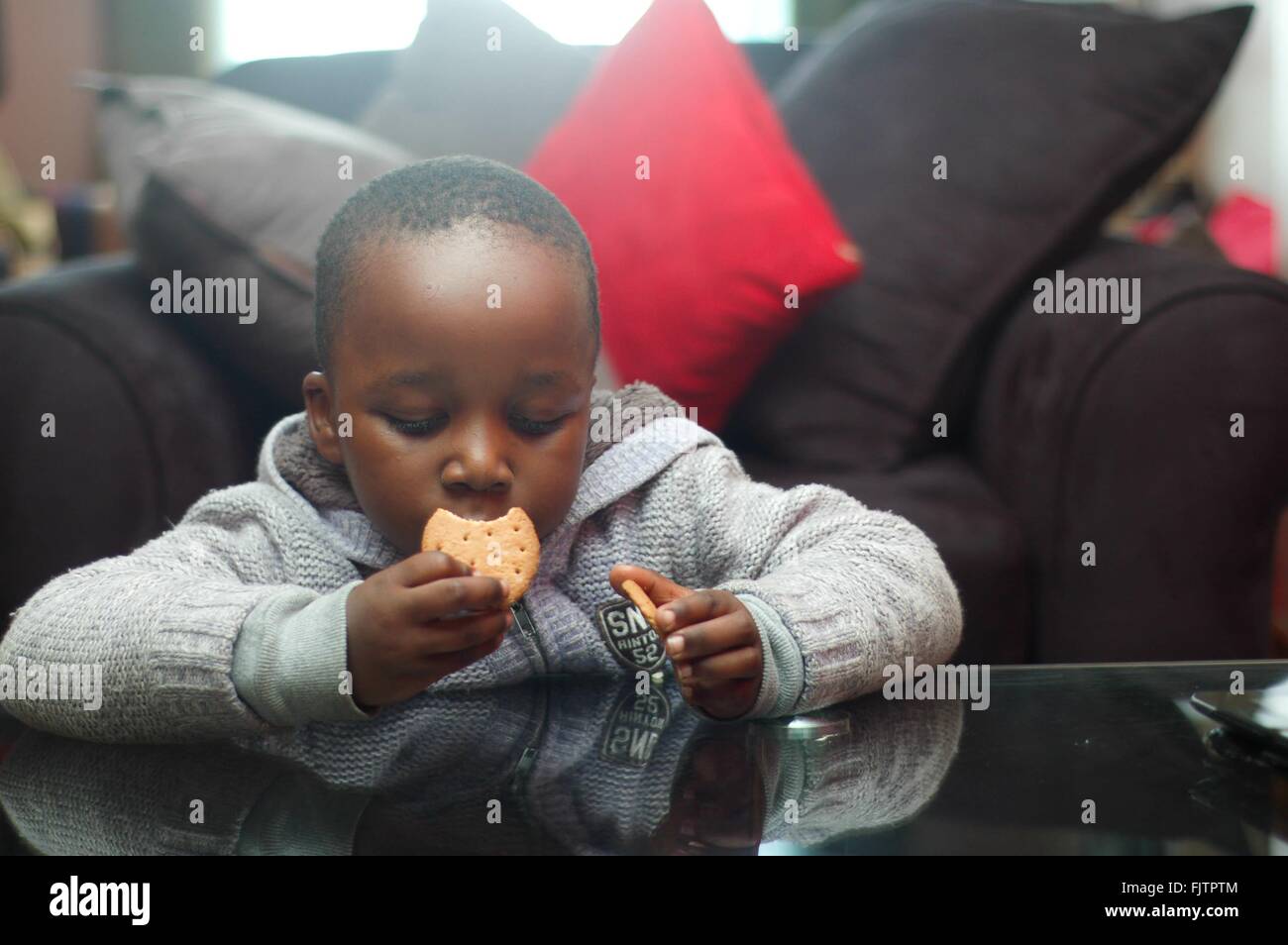 Boy eating biscuit hi-res stock photography and images - Alamy