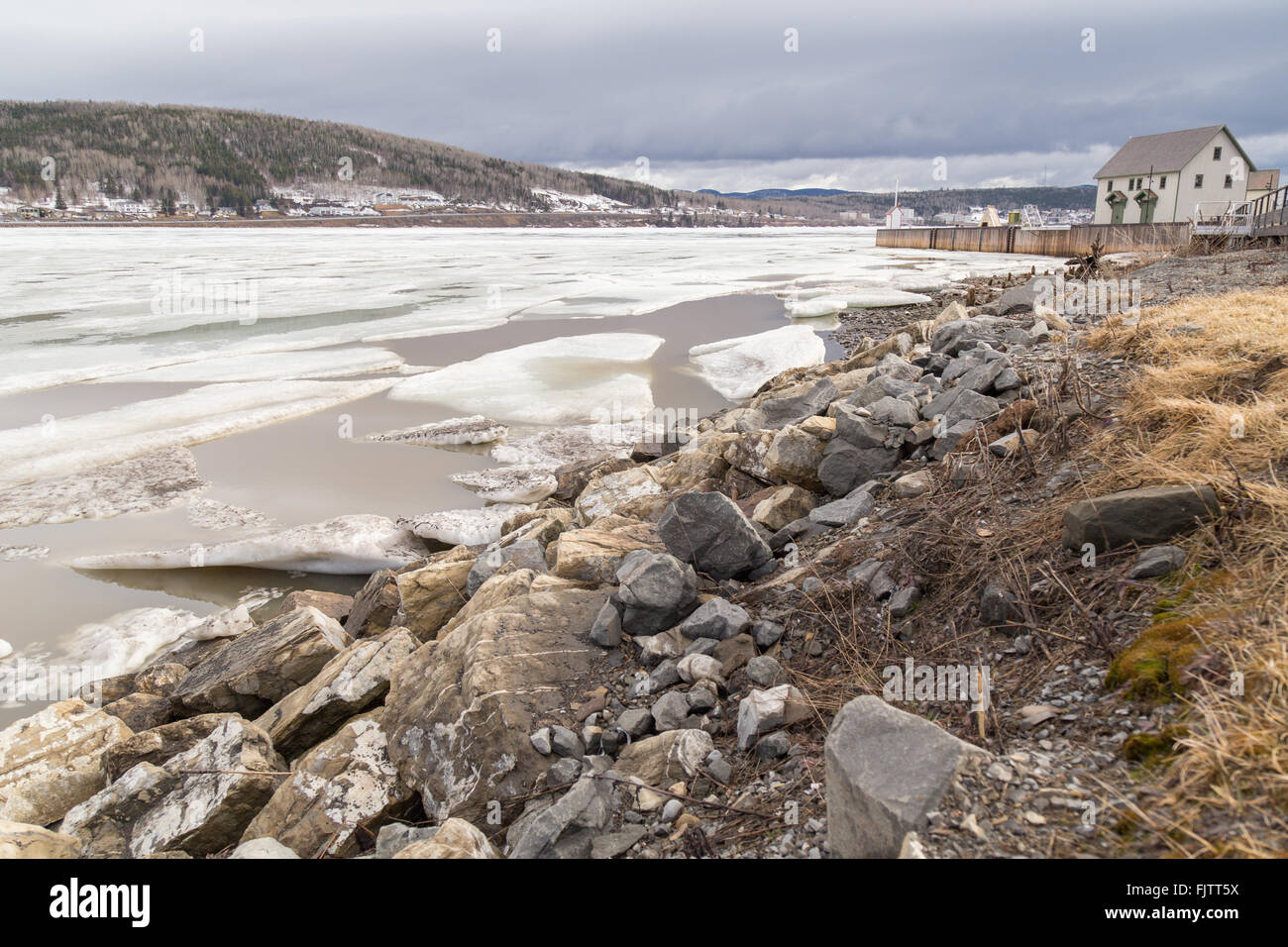 Rocky riverside and floating ice chunks on the St Lawrence River in ...