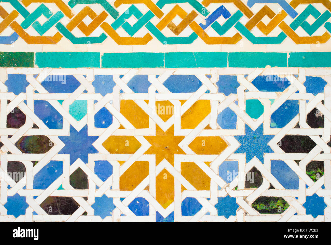 colorful ornate pattern of moorish tile decorations on alhambra wall in ...