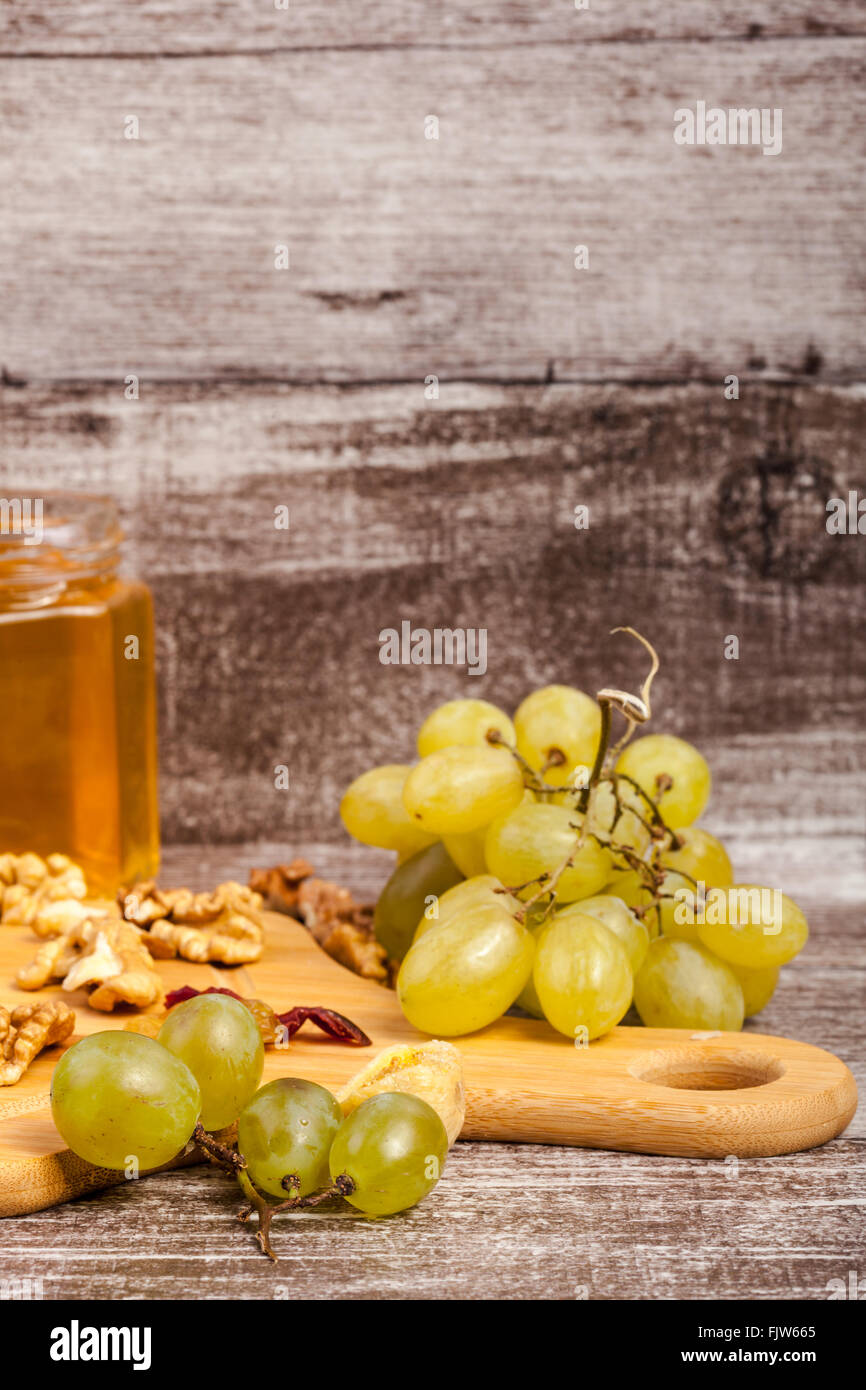 Nuts, honey and grape on wooden background in studio photo Stock Photo ...