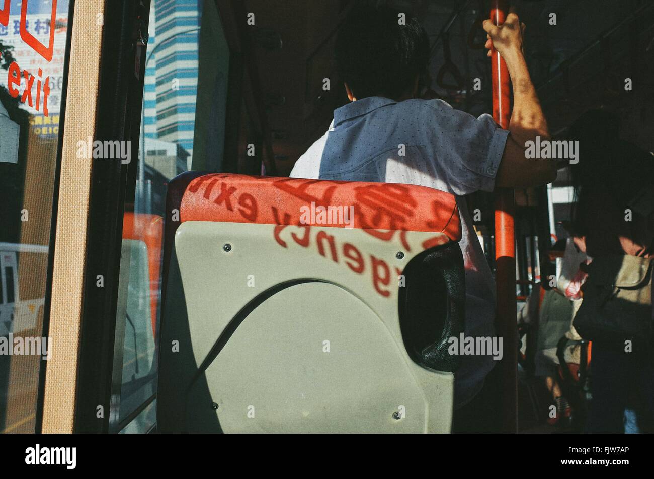 Rear View Of Man Traveling In Bus Stock Photo - Alamy