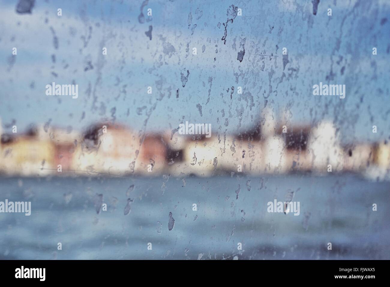 Waterdrops On Glass With River Against Built Structures Stock Photo - Alamy