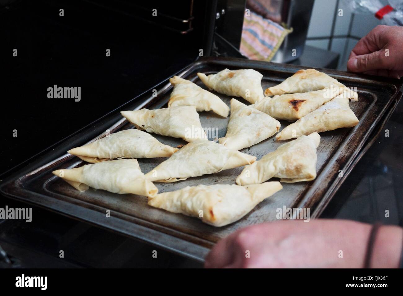 Cropped Image Of Hand Holding Samosas In Tray Stock Photo - Alamy