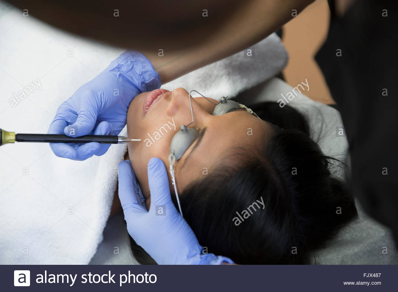 Woman and facial treatment hi-res stock photography and images - Alamy