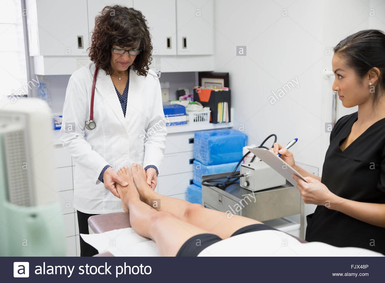 Doctor examining foot woman hi-res stock photography and images - Alamy
