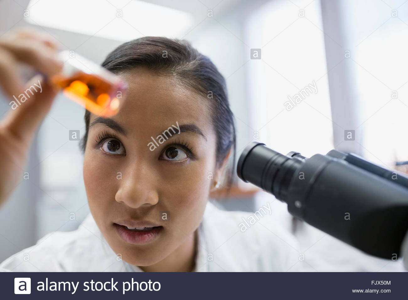 Close up medical scientist examining liquid at microscope Stock Photo ...