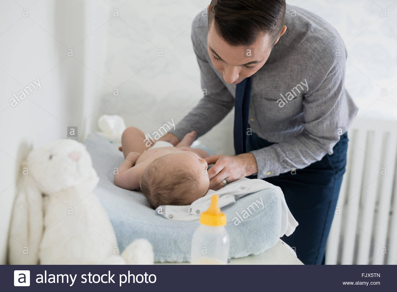 Man changing baby hi-res stock photography and images - Alamy