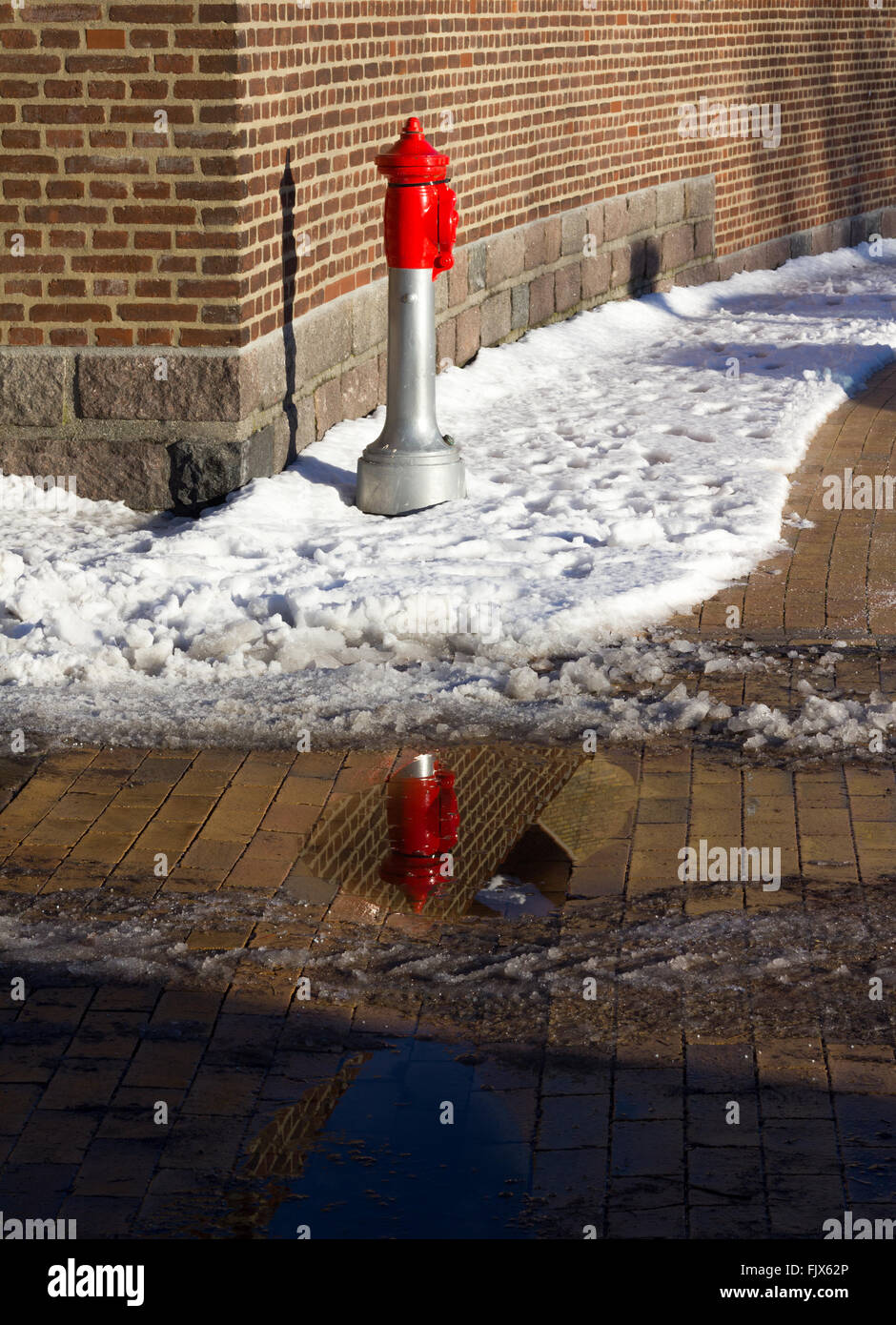 Fire Hydrant With Snow Against Building During Winter Stock Photo - Alamy
