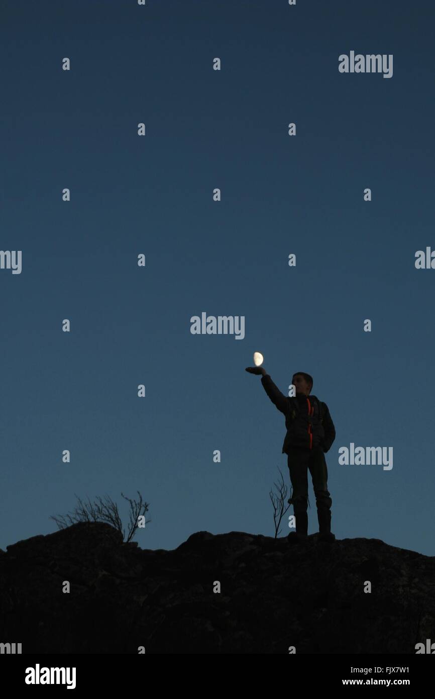 Holding the moon illusion hi-res stock photography and images - Alamy