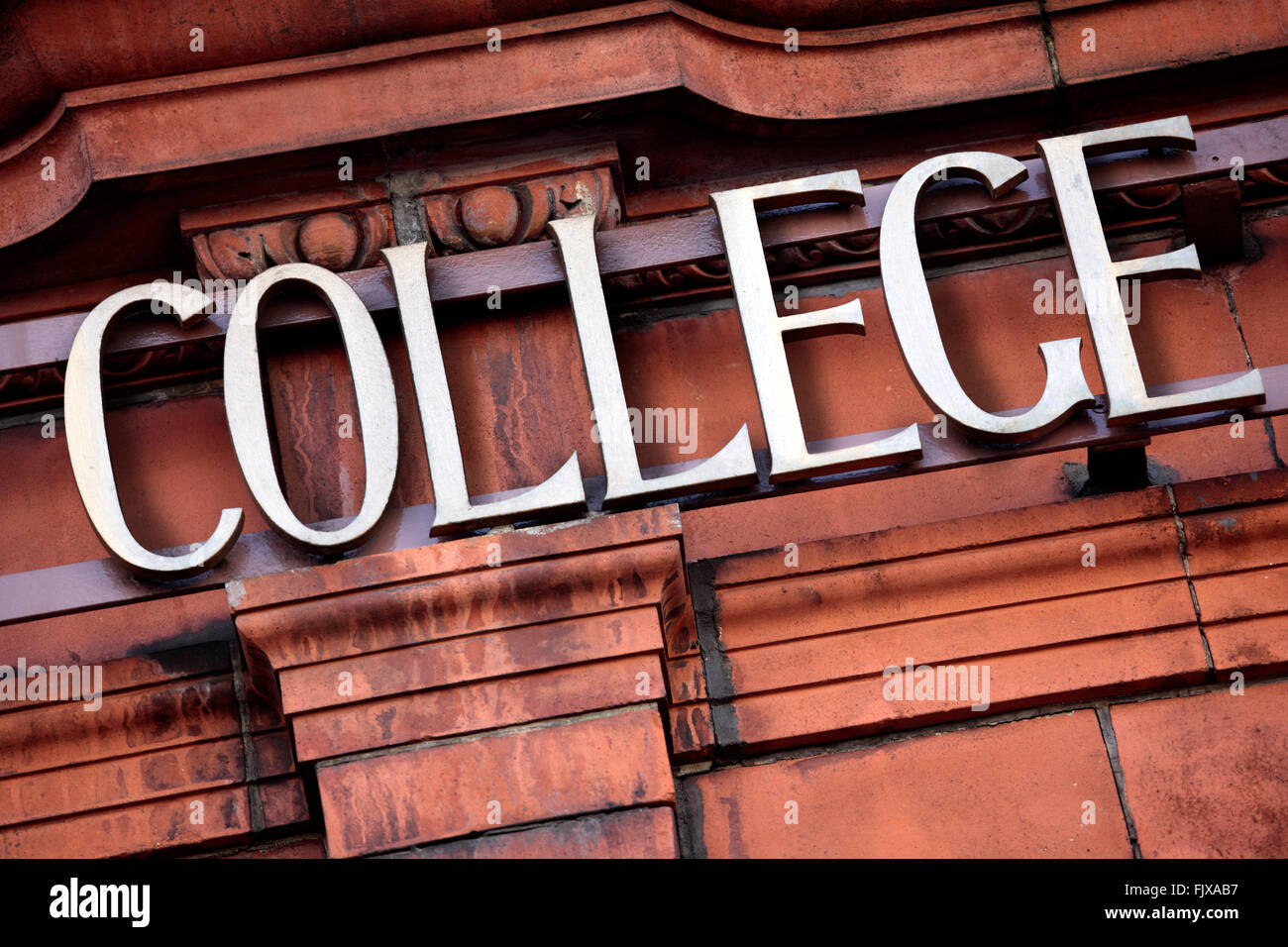 Sign above the entrance to a college building Stock Photo - Alamy