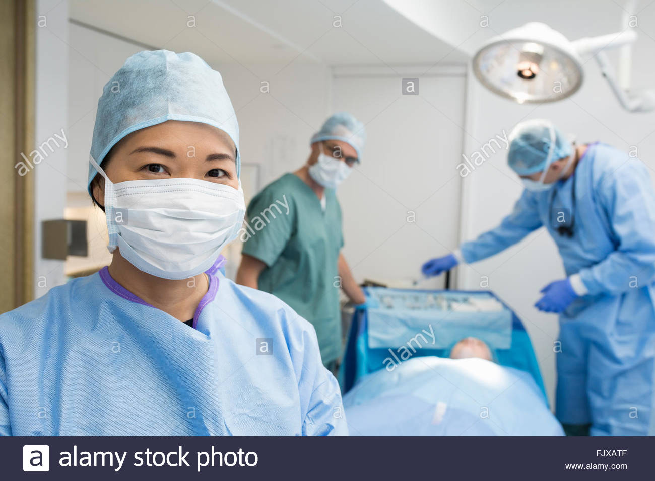 Portrait confident plastic surgeon in operating room Stock Photo - Alamy