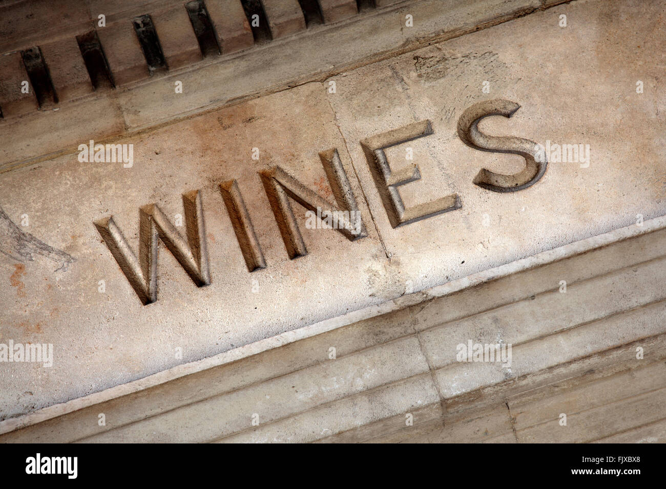 Very old wine sign carved into the stone entrance of a wine cellar ...