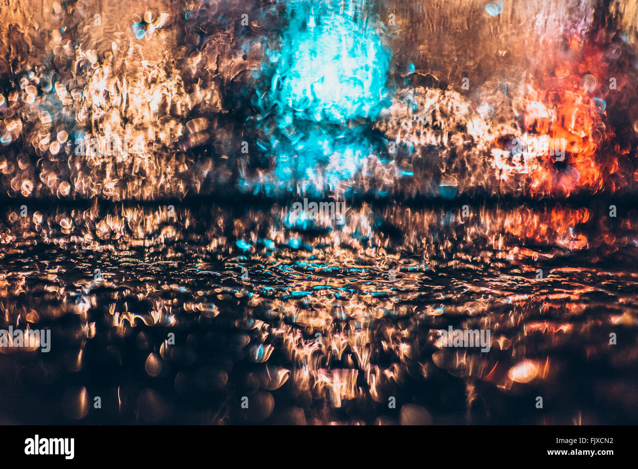 Illuminated Water In Puddle During Rainy Season Stock Photo - Alamy
