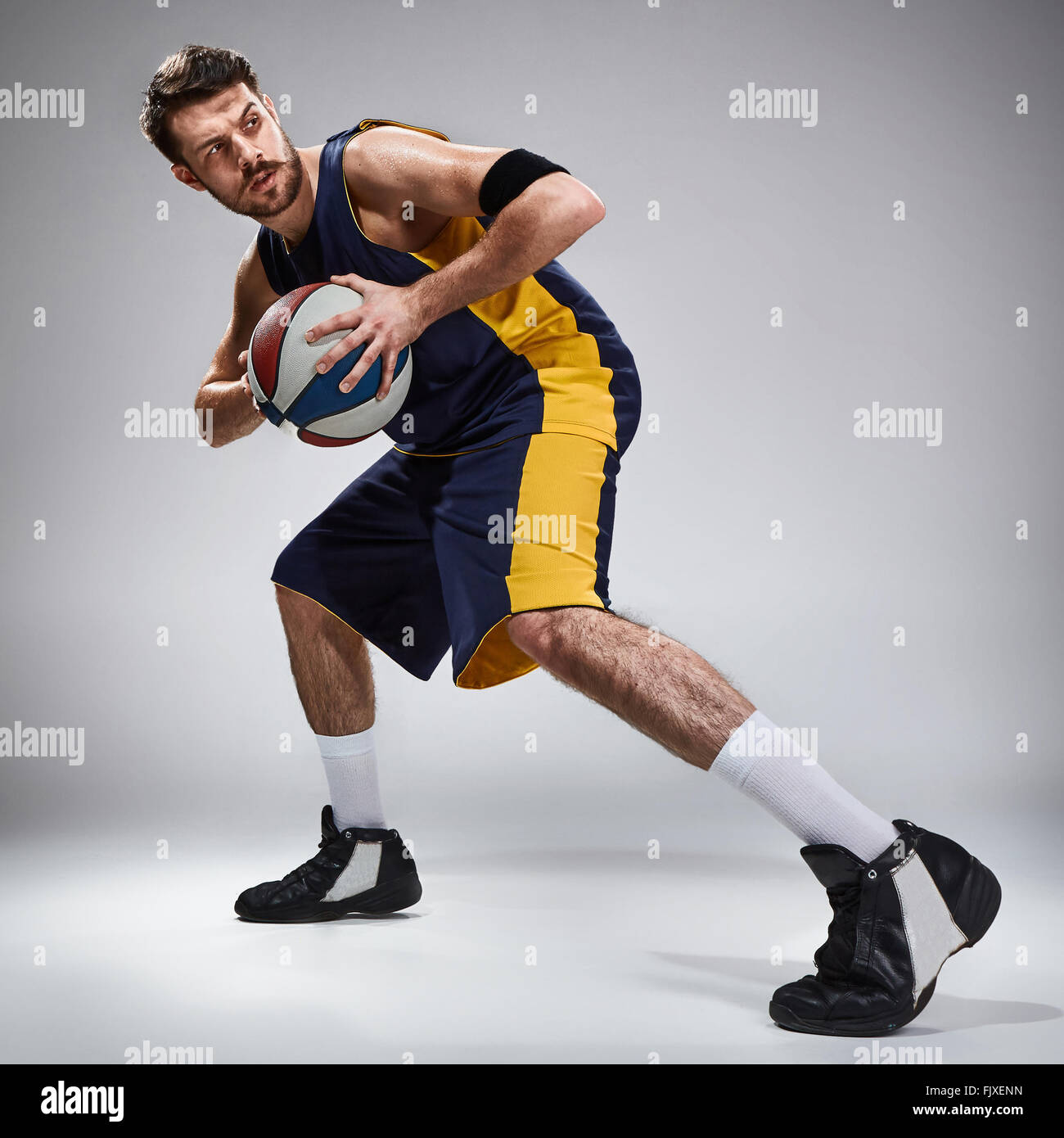 Full length portrait of a basketball player with ball Stock Photo - Alamy