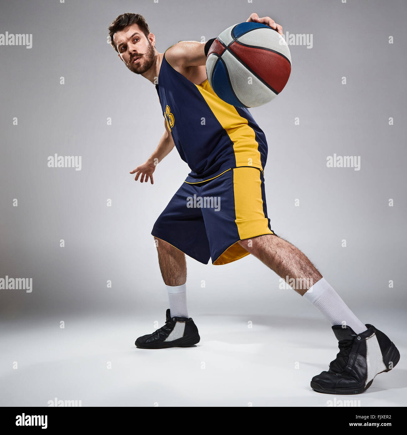 Full length portrait of a basketball player with ball Stock Photo - Alamy