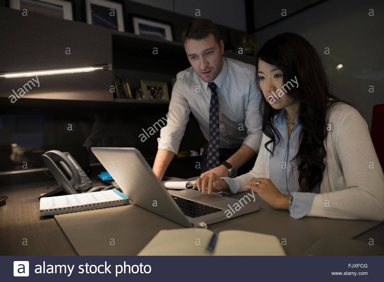Business people working late at laptop in office Stock Photo - Alamy
