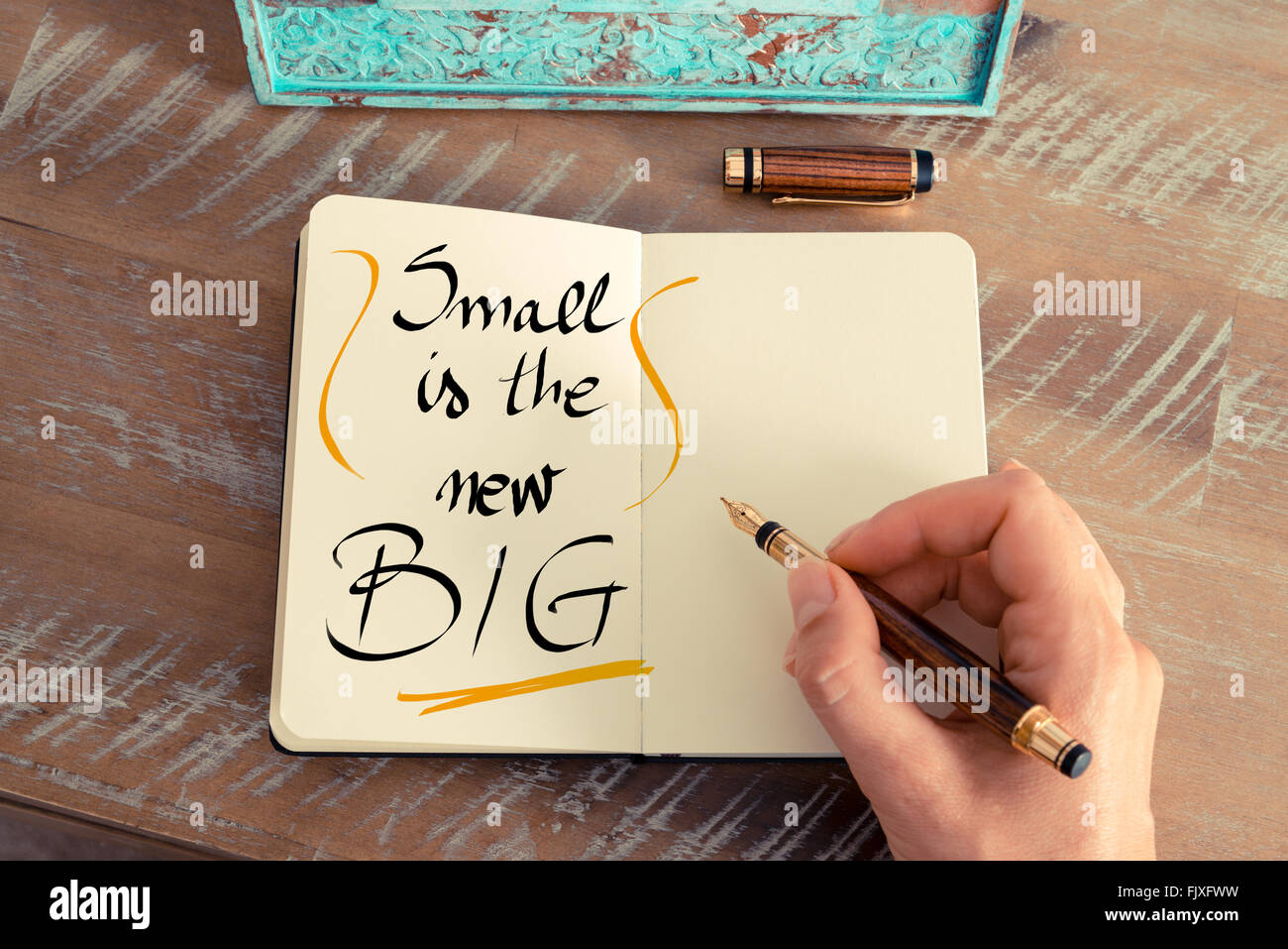 Retro effect and toned image of a woman hand writing a note with a ...
