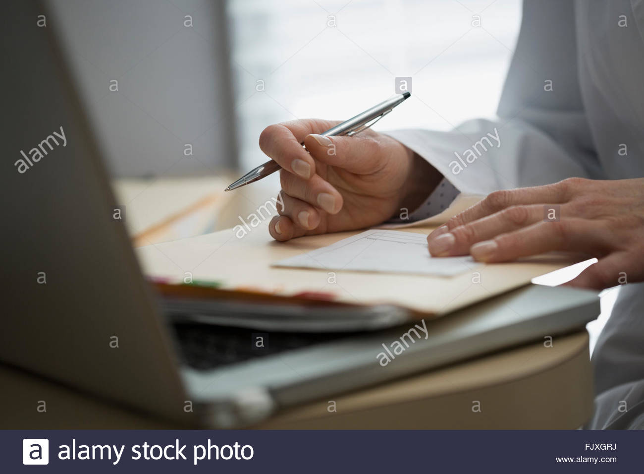 Doctor writing laptop hi-res stock photography and images - Alamy