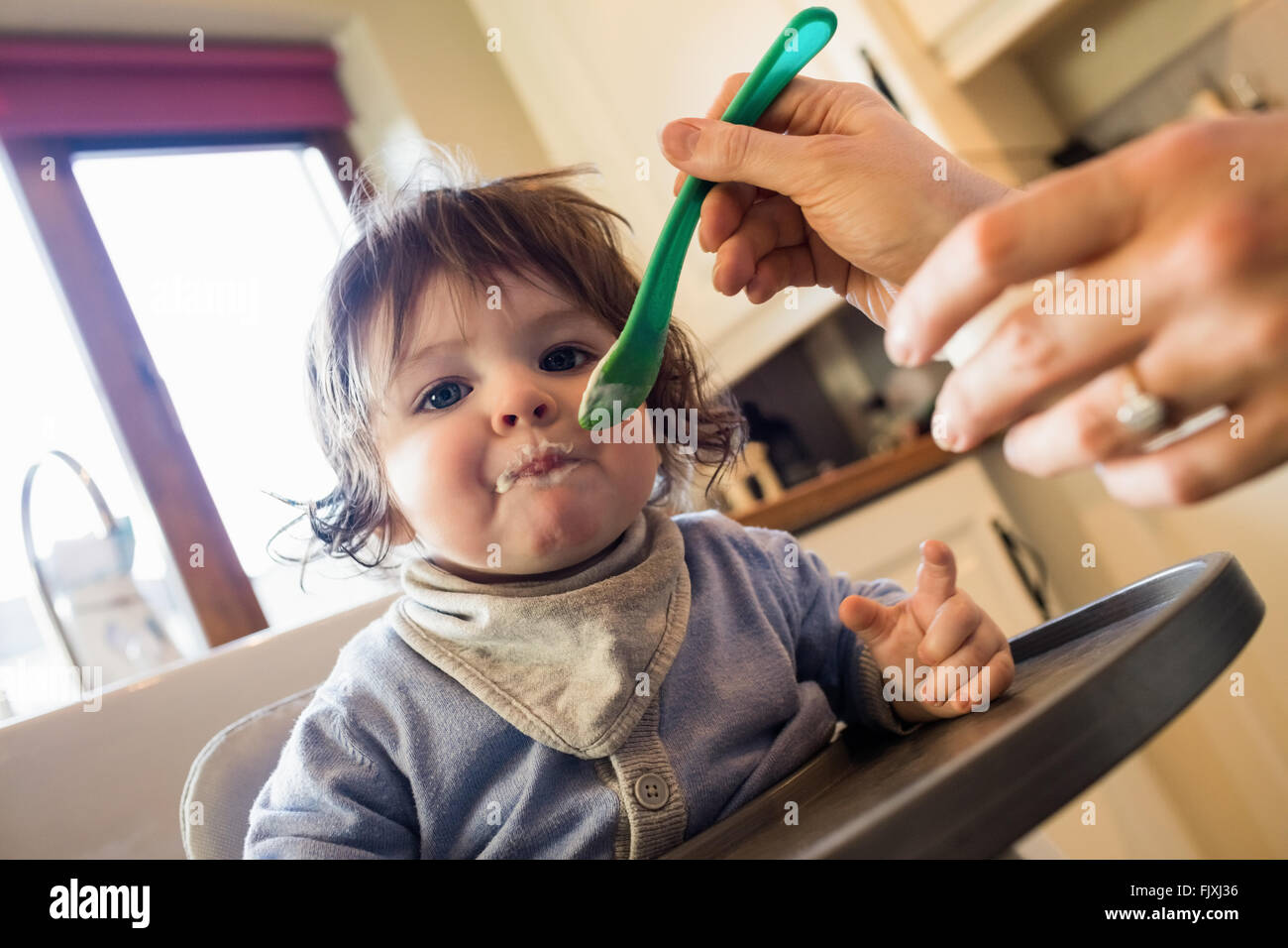 Cute mother feeding her baby Stock Photo - Alamy