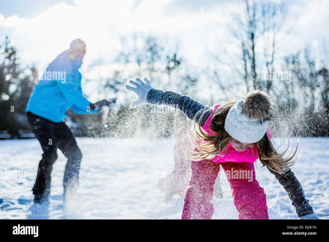 Father and daughter playing snowball fight Stock Photo - Alamy