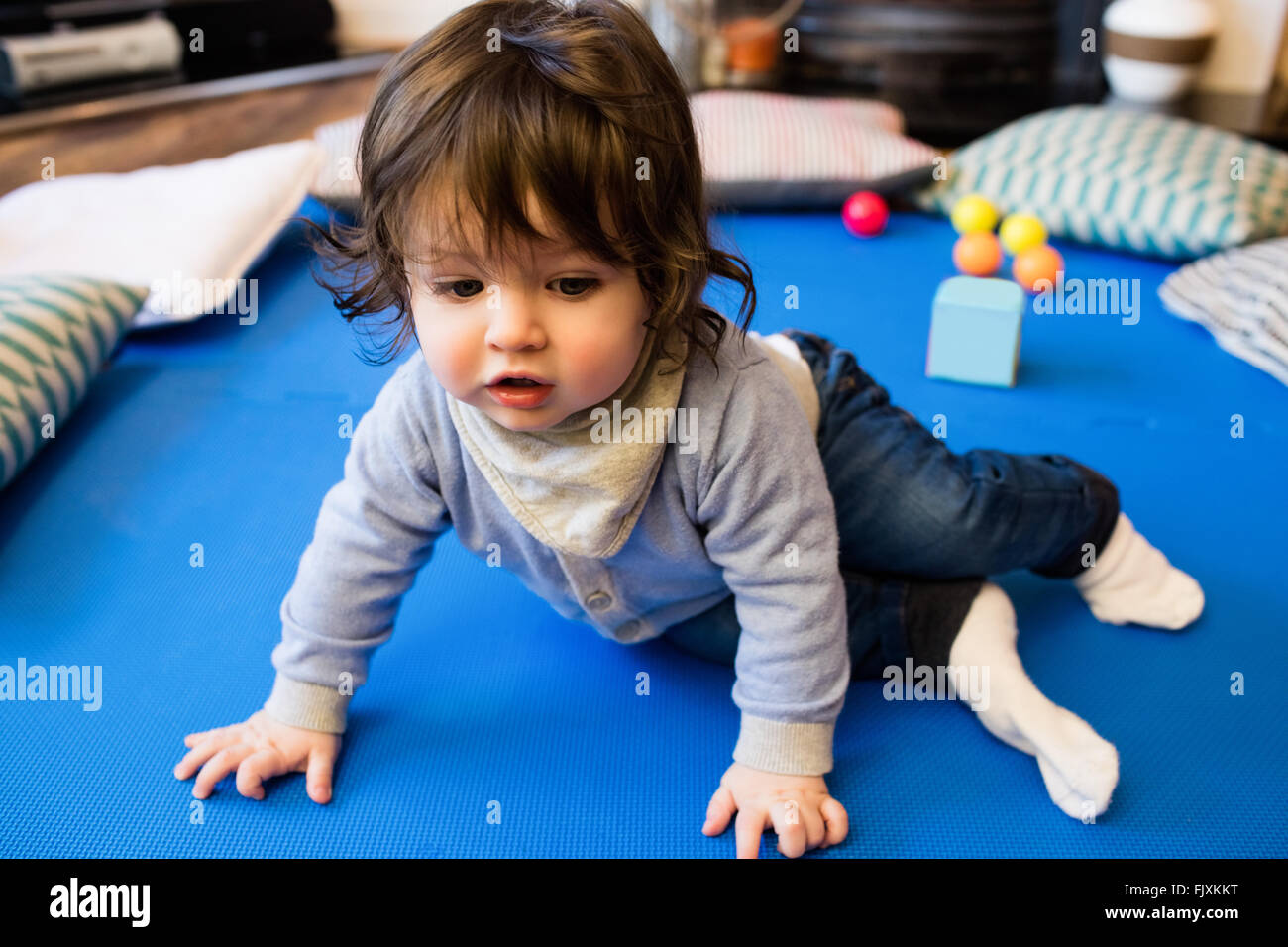 Cute baby playing on the carpet Stock Photo - Alamy