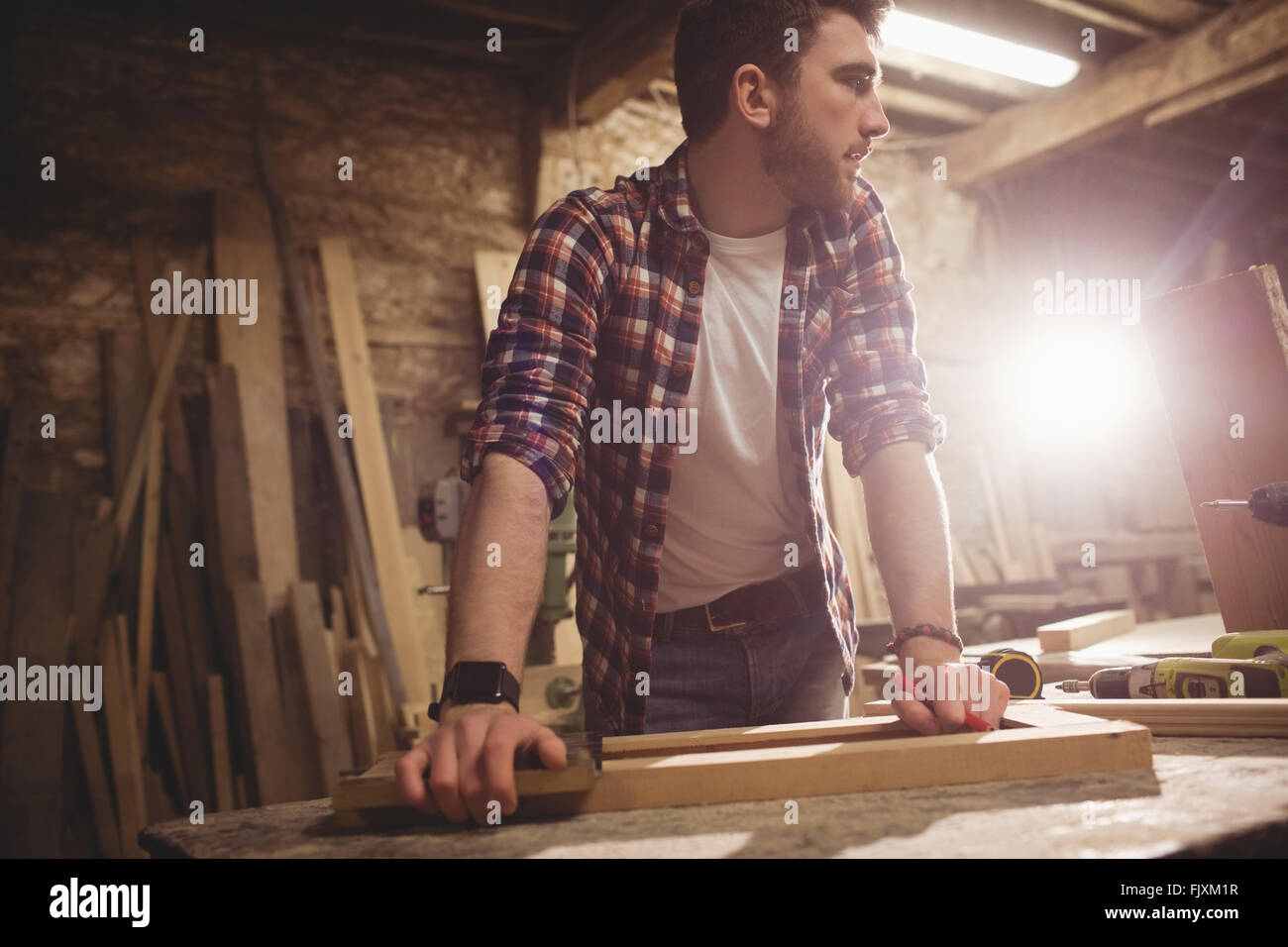 Happy carpenter working on his craft Stock Photo - Alamy